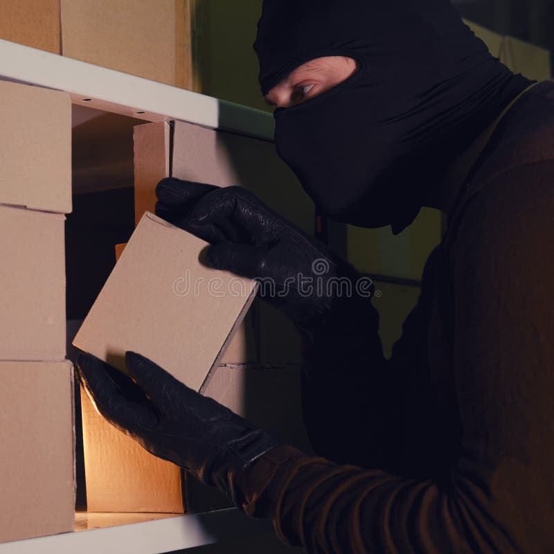 Theft of a Box with a Parcel in a Warehouse. Man Hands in Gloves Steal ...