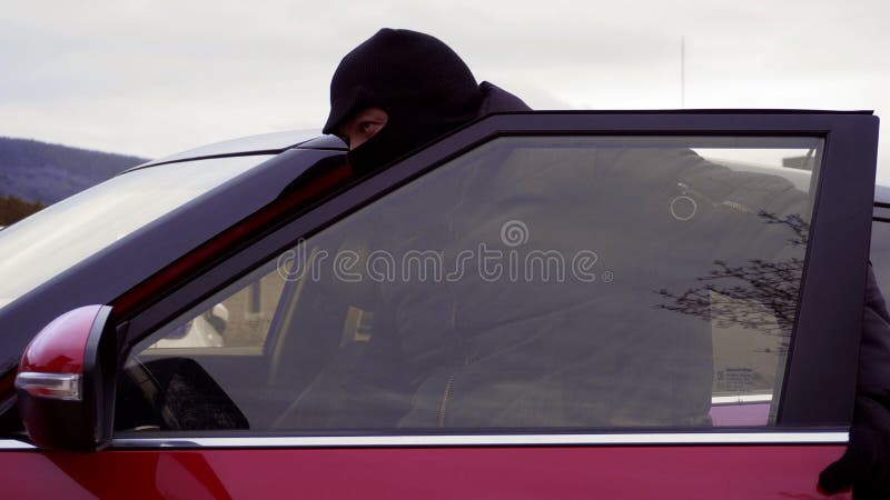 Thief in Black Mask, Steals a Car, Red Stock Image - Image of wheel ...