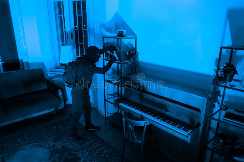 Thief Examining Objects on a Shelf at Night Stock Photo - Image of ...