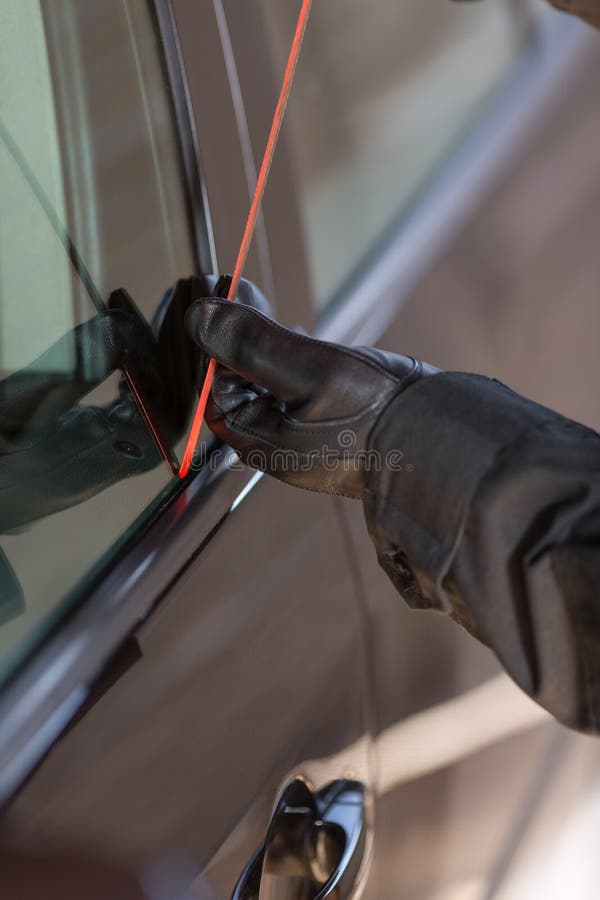 Car Thief Using a Tool To Break into a Car. Stock Photo - Image of ...