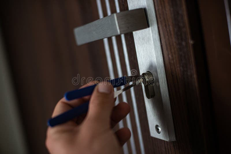 Thief Opening a Lock with Picklock. a Burglar& X27;s Hand with a ...
