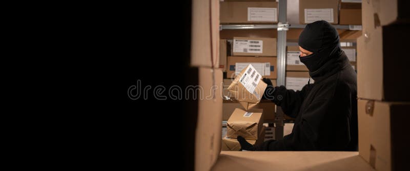 A Thief Stealing Boxes in a Warehouse at Night in the Dark. Warehouse ...
