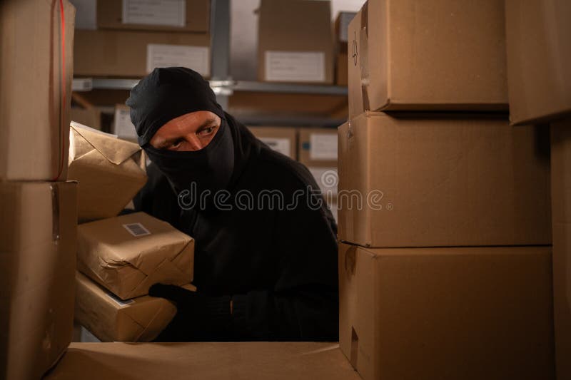A Thief Stealing Boxes in a Warehouse at Night in the Dark. Warehouse ...