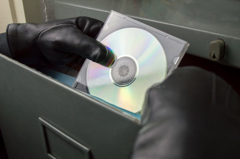 Thief Stealing Documents in Compact Disc Stock Photo - Image of hide ...