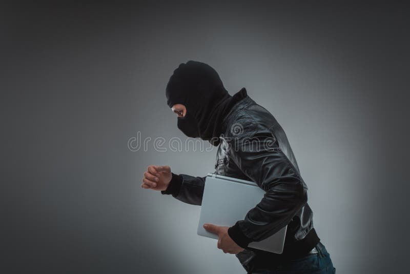 Thief Stealing a Laptop Computer. Isolated on Gray Background Stock ... Thief Stealing a Laptop Computer. Isolated on Gray Background Stock ...