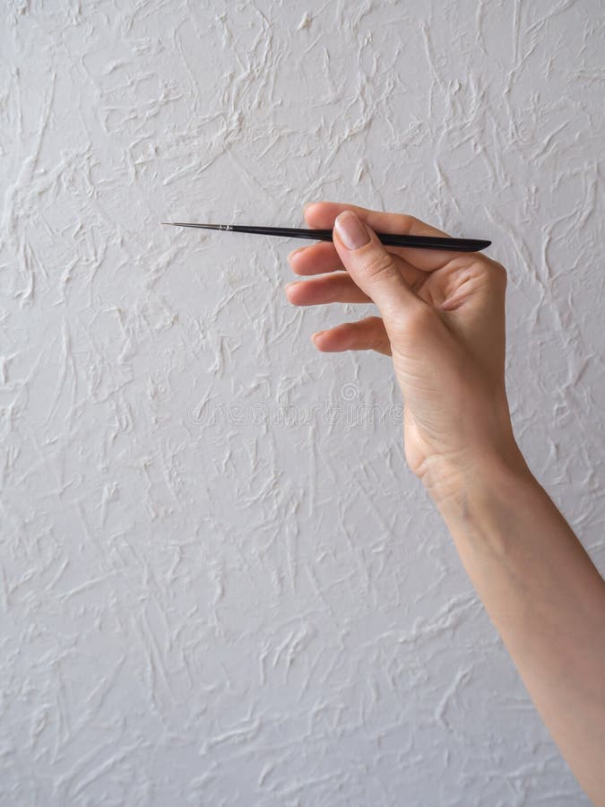 A Thin Brush for Drawing in a Woman`s Hand. Stock Photo - Image of hand ...