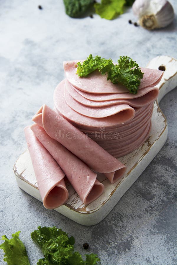 Thin Ham Slices Rolled on Cutting Board. Bright Background Stock Image ...