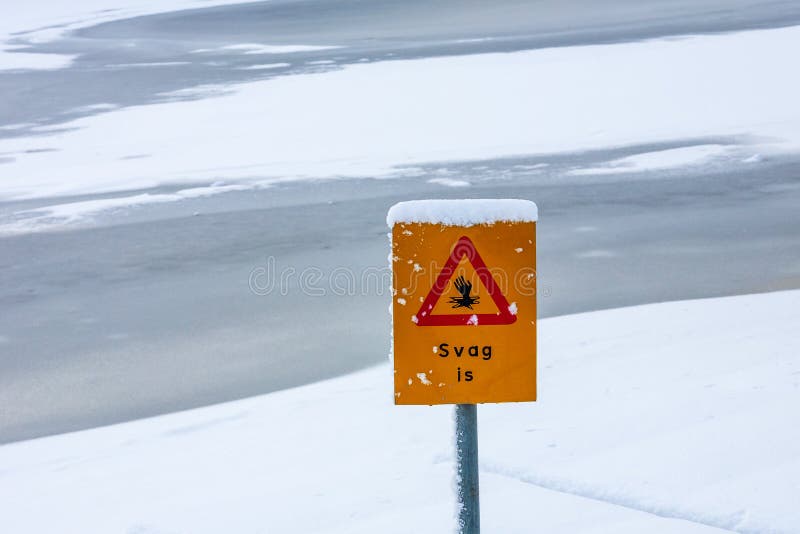 Thin Ice Warning Sign by a Lake Stock Photo - Image of water, snow ...