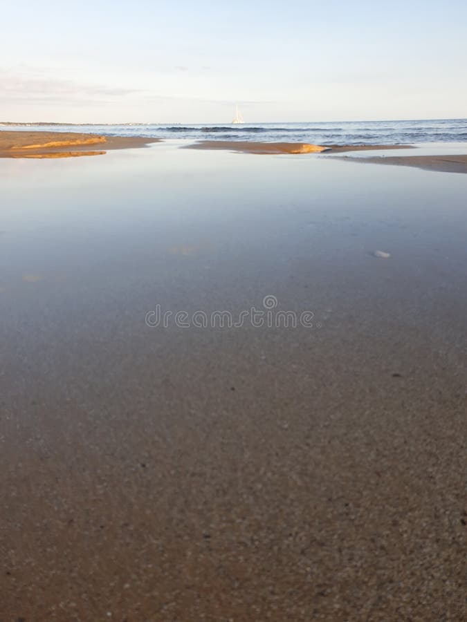 A Thin almost Invisible Layer of Sea Water Reflecting the Pale Blue Sky ...