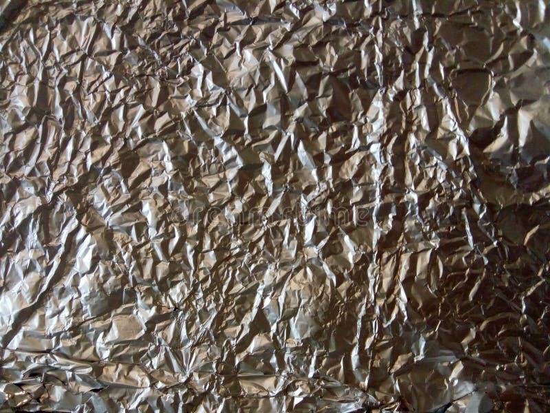 A Thin Leaf on a Silver Leaf Background with a Shiny, Wrinkled, Uneven ...