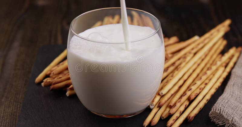 Thin and Long Bread Sticks and a Glass of Milk Stock Video - Video of ...