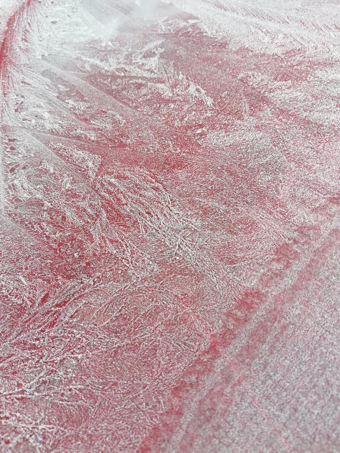 Thin Shiny Layer of Ice on a Red Background Stock Photo - Image of ...