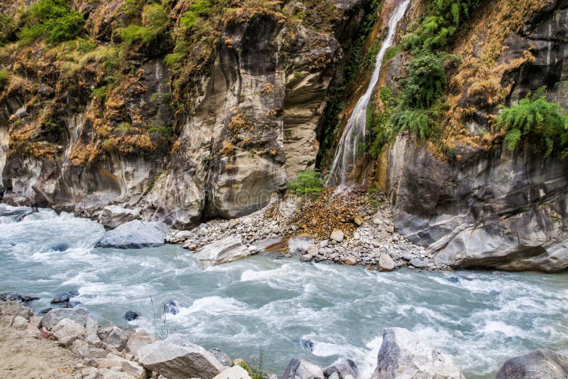 A Thin Stream Flows from the Mountain into the River Stock Photo ...