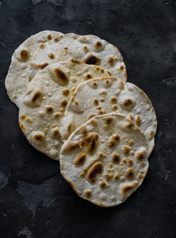 Thin Tortilla Flatbread on a Dark Background, Top View Stock Photo ...