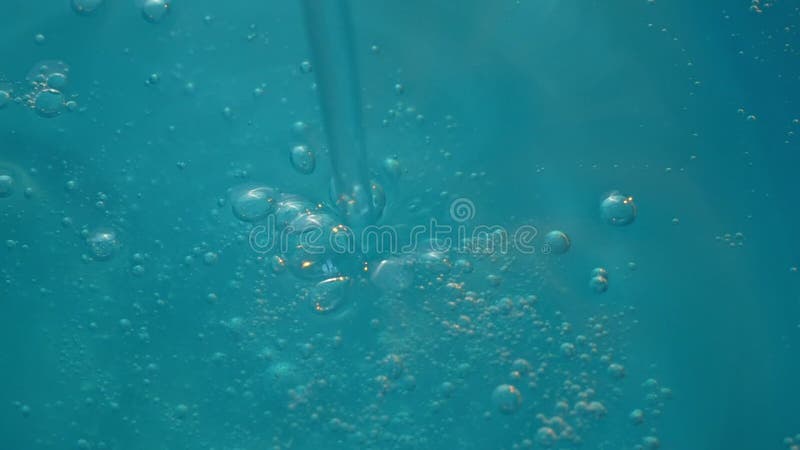 A Thin Trickle of Transparent Blue Cosmetic Gel with Tiny Bubbles ...