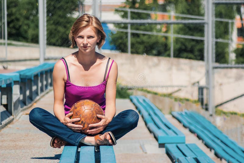 A Thin Young Girl on a Blue Bench on a Sports Stand Stock Image - Image ...
