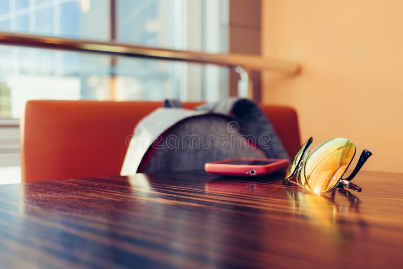 Things on a Table in a Cafe: Sun Glasses, Pink Smart Phone and a Stock ...