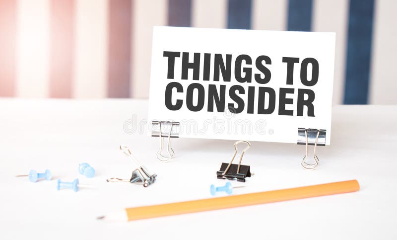 THINGS TO CONSIDER Sign on Paper on White Desk with Office Tools. Blue ...