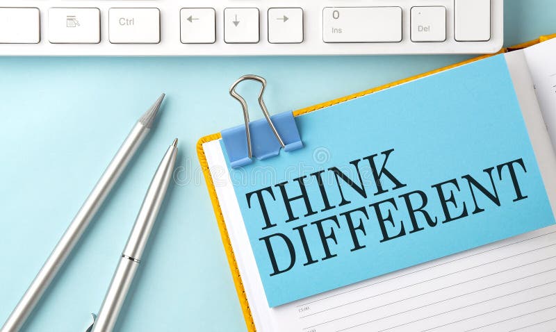 THINK DIFFERENT Text on Sticker on the Blue Background with Pen and ...