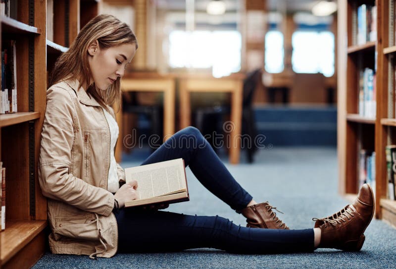 Think Ill Study Right Here. a University Student Reading a Book in the ...