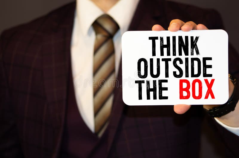 Think Outside the Box. Businessman Holding a Signboard with a Message ...