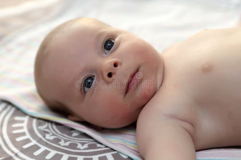 Thinking baby boy on a bed stock image. Image of childhood - 59566293