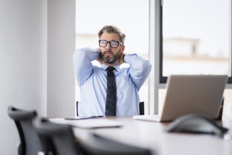 Thinking Businessman Working on Laptop at the Office Stock Photo ...