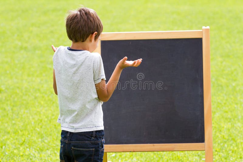 Thinking Child by the Blackboard Outdoors Stock Image - Image of ...