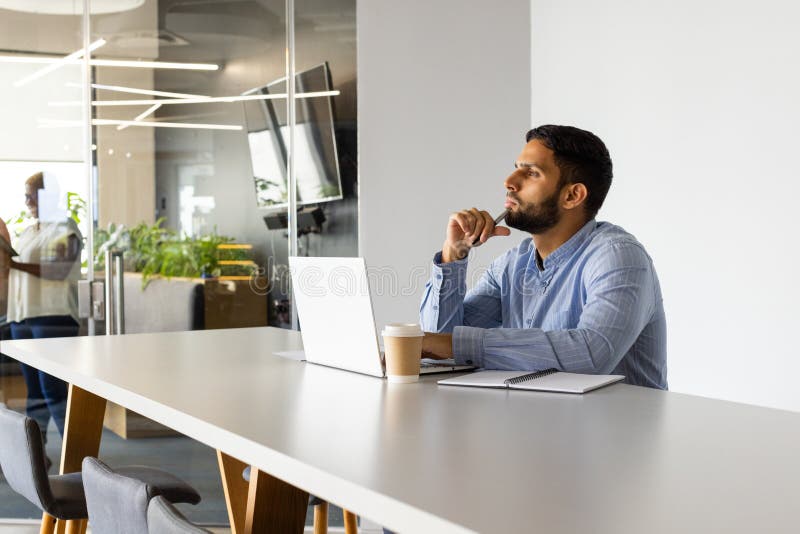 Thinking Deeply, Man Working on Laptop with Coffee Cup in Modern Office ...