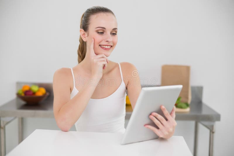 Thinking Happy Young Woman Using Her Tablet at Table Stock Photo ...