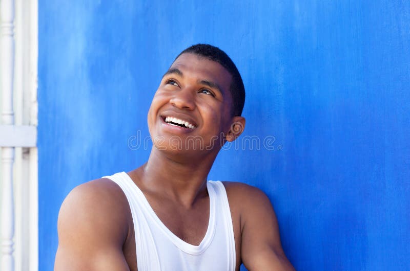 Thinking Latin Guy in Front of a Blue Wall Stock Image - Image of hair ...