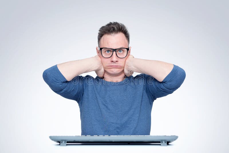 Thinking Man in Glasses Behind a Keyboard in Front of a Computer ...