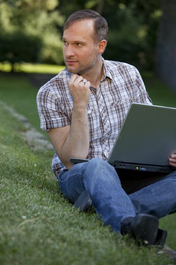 Thinking man with laptop stock photo. Image of outdoor - 10386536