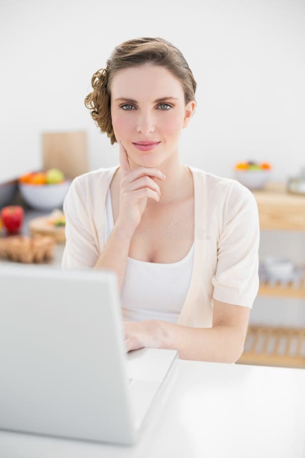 Thinking Pretty Woman Sitting in Kitchen Using Her Notebook Stock Photo ...