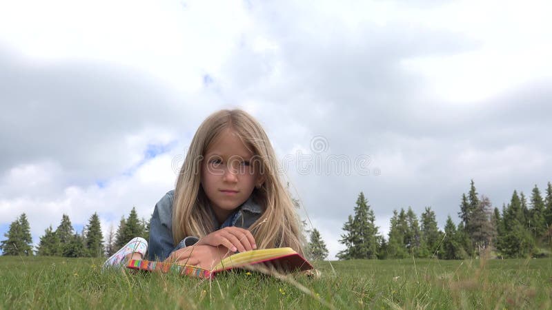 Thinking Sad Child Reading a Book on Meadow, Kid Studying Outdoor on ...