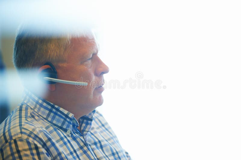 Thinking Things through. a Senior Businessman Wearing a Headset Looking ...
