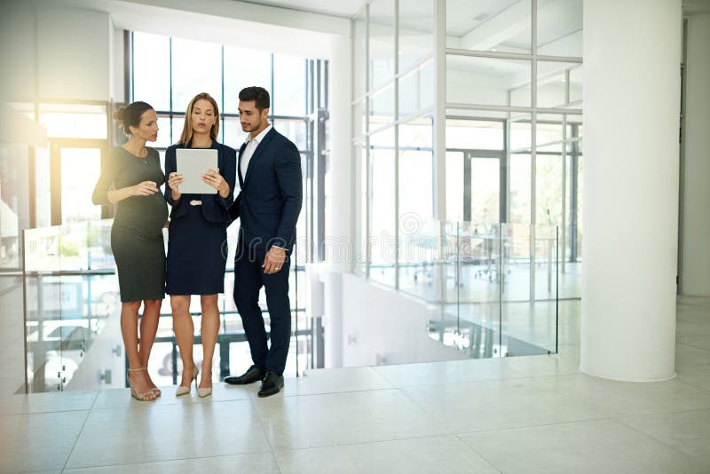 Thinking in Threes. a Group of Businesspeople Talking Together Over a ...