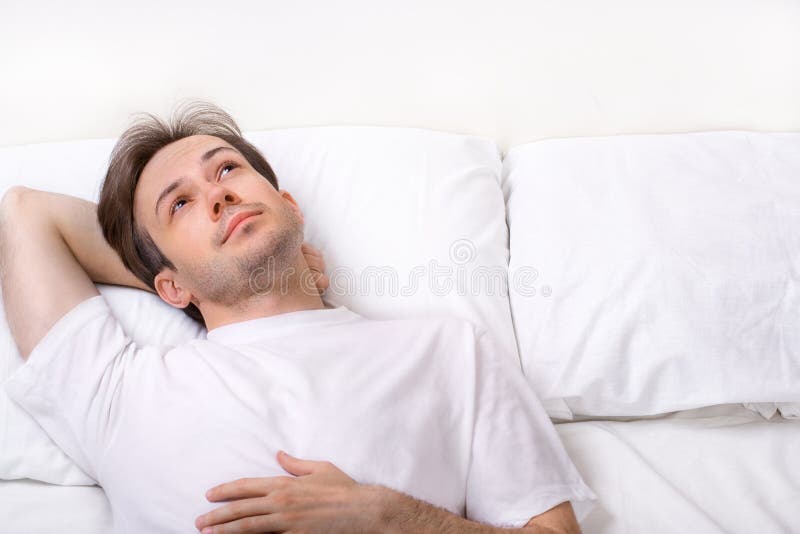 Thinking Young Man Lying on Bed Stock Photo - Image of pensive, human ...