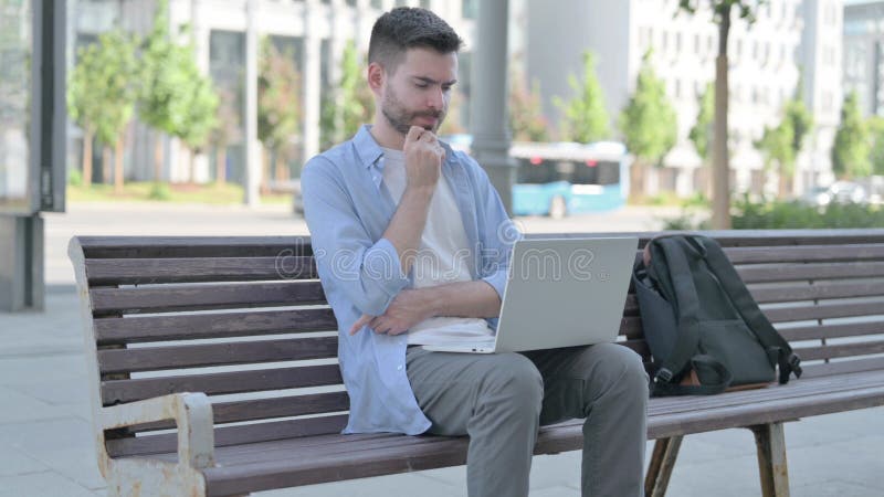 Thinking Young Man Using Laptop while Sitting on Bench Stock Image ...