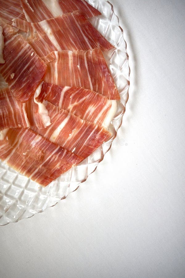 Thinly Sliced Iberian Ham on a Crystal Plate. Stock Image - Image of ...