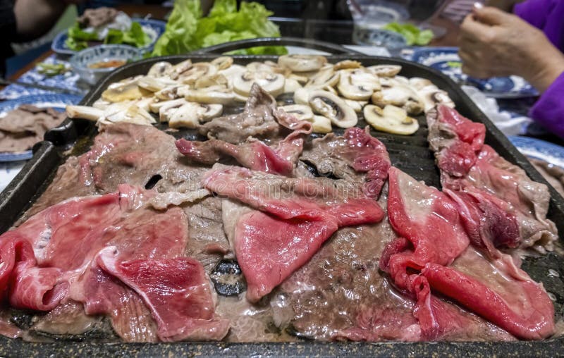 Thinly Sliced Pieces of Beef and Button Mushrooms in the Process of ...