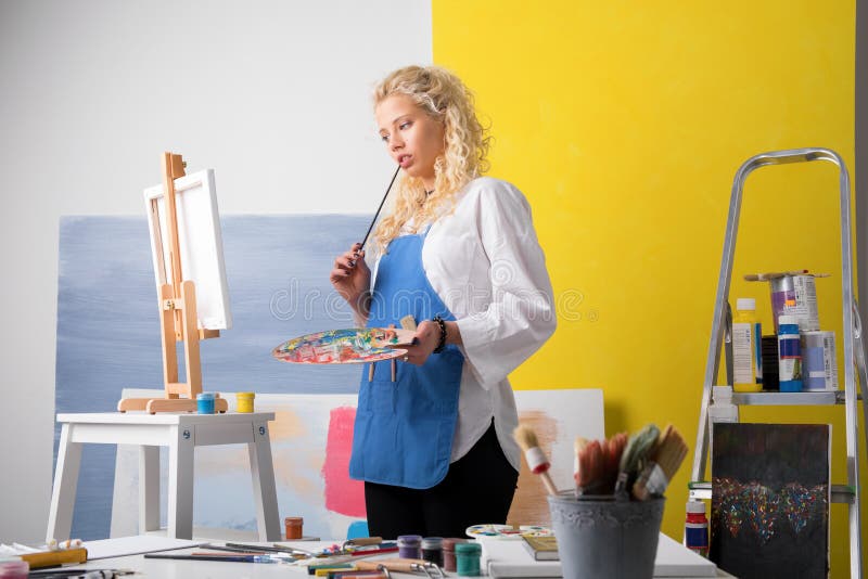 Thoughtful Artist Looking at Her Painting Stock Photo - Image of ...