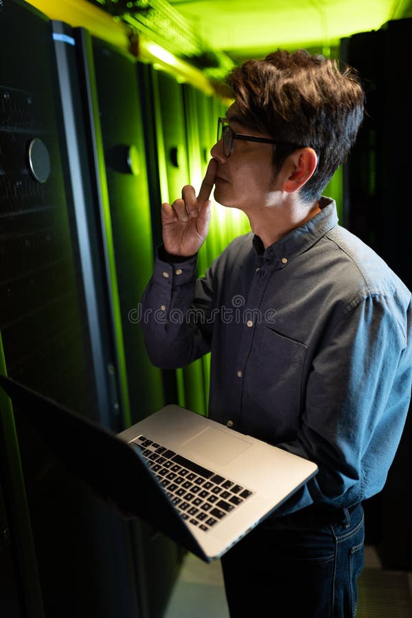 Asian Male Hacker Using a Laptop in Computer Server Room Stock Image ...