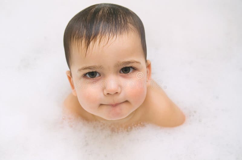 Thoughtful baby in foam stock image. Image of innocence - 5259355