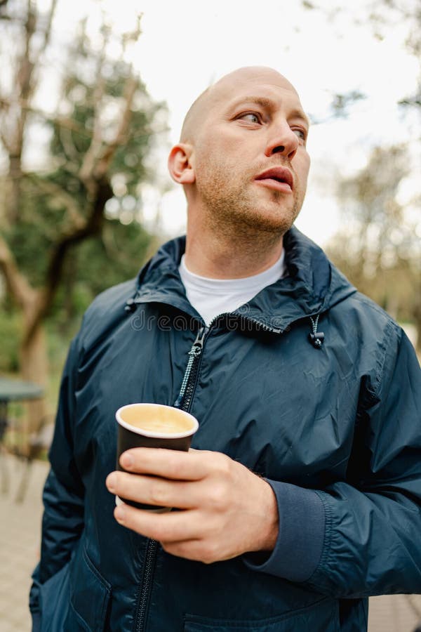 Thoughtful Bald Man with Disposable Coffee Cup in the Street Stock ...