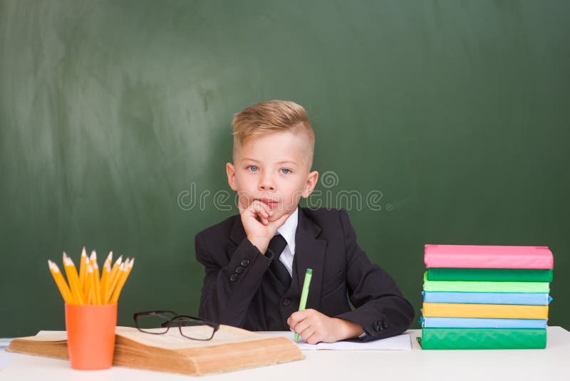 Thoughtful Boy in Classroom Stock Image - Image of copyspace, pile ...