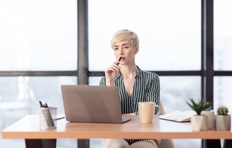 Thoughtful Business Lady at Laptop Thinking Working at Workplace Stock ...