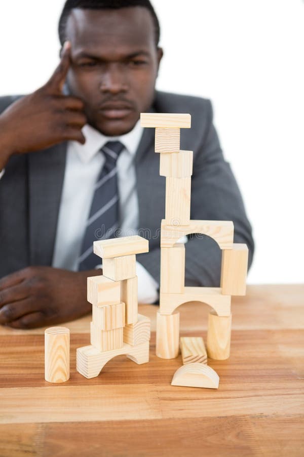 Thoughtful Businessman Building Tower of Wooden Blocks Stock Image ...