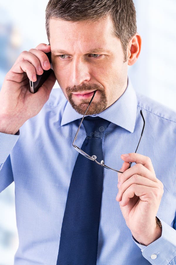 Thoughtful Businessman Making a Phone Call. Stock Photo - Image of blue ...