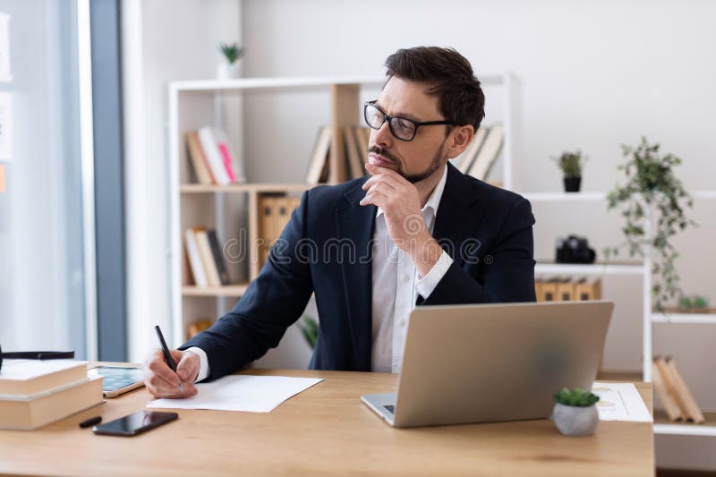 Thoughtful Businessman Taking Notes Office Desk Laptop Documents Stock ...
